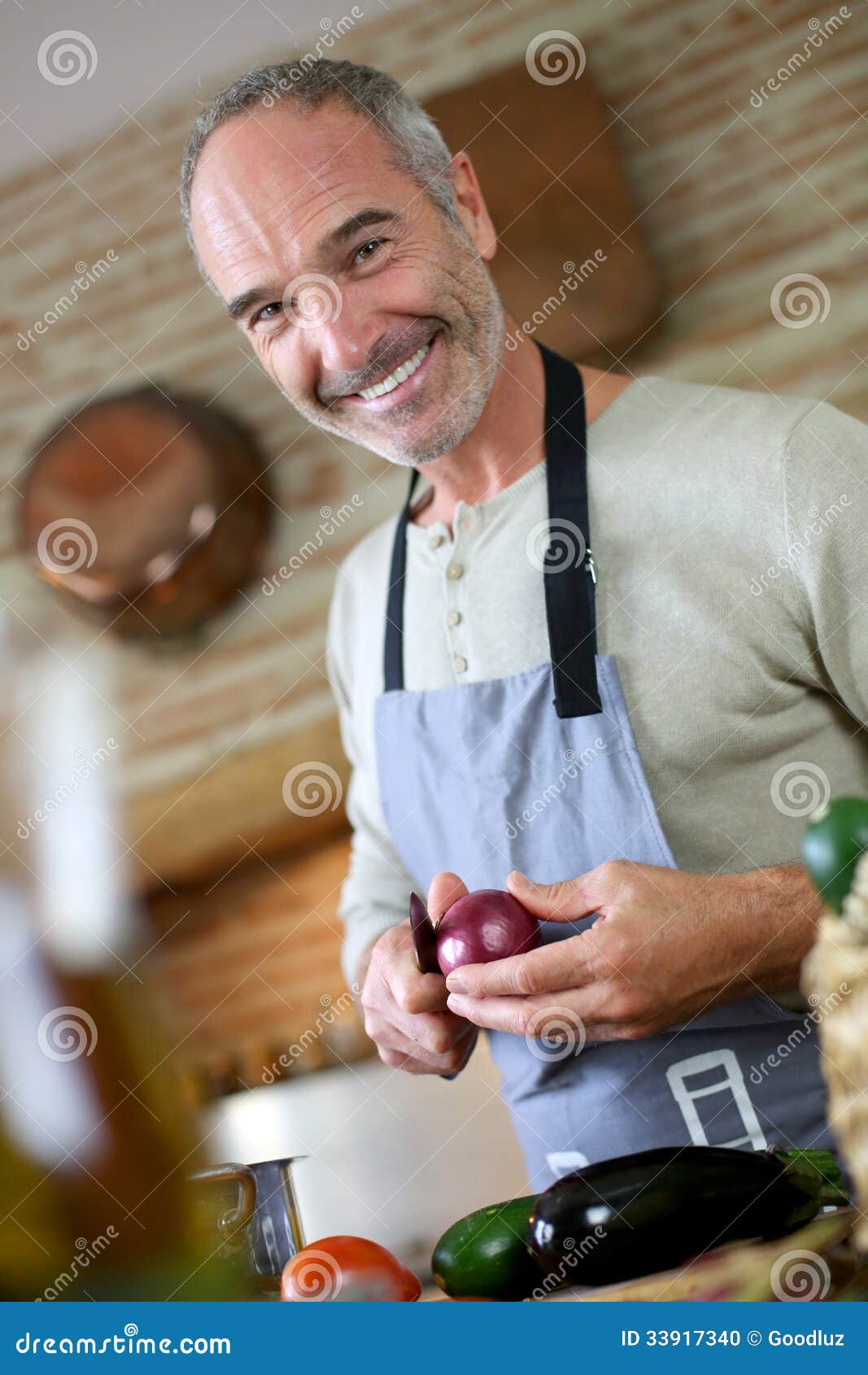 Mature man cooking at home stock photo. Image of kitchen - 33917340