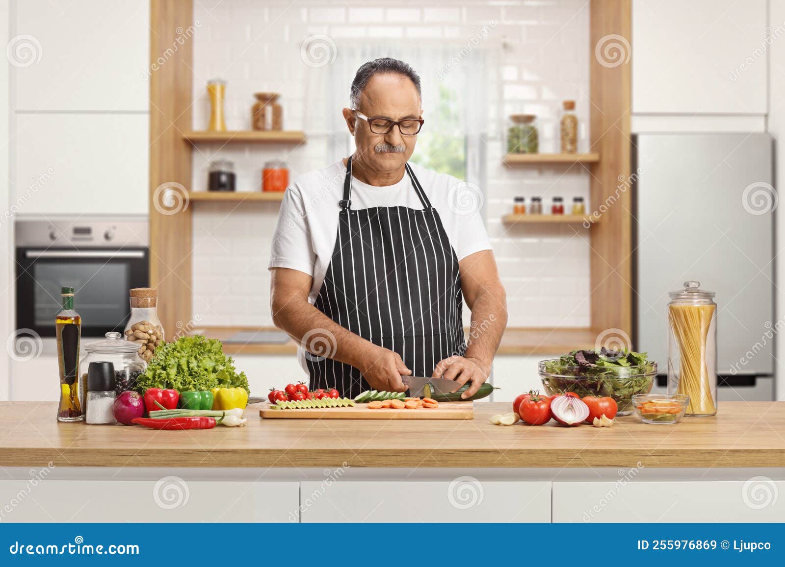 Mature Man Cutting Vegetables and Preparing a Salad Stock Image - Image ...