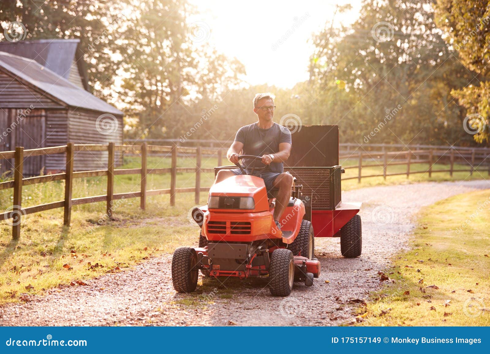 Mature Man Driving Ride on Mower Along Garden Path Stock Image - Image ...