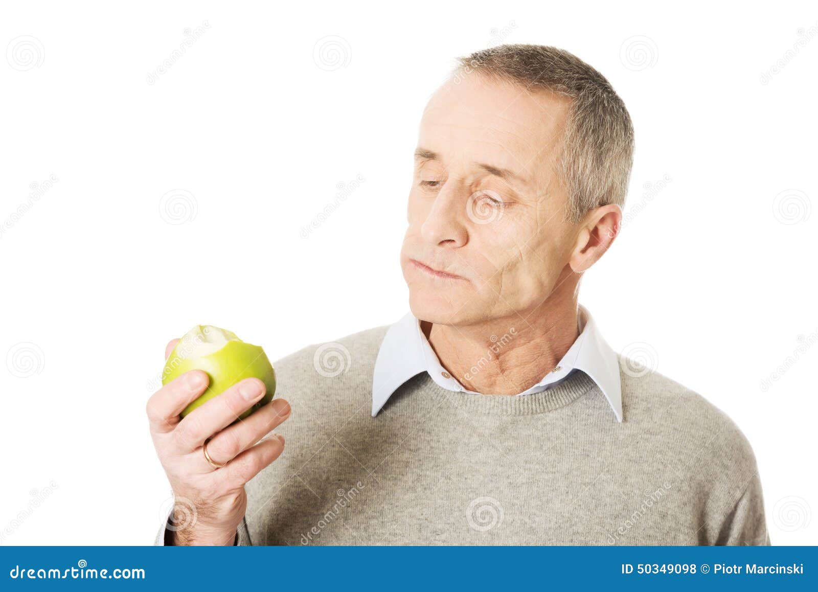 Mature man eating an apple stock photo. Image of hold - 50349098