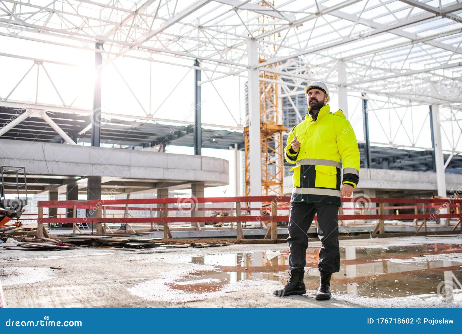 Man Engineer Standing on Construction Site, Using Smartphone. Stock ...