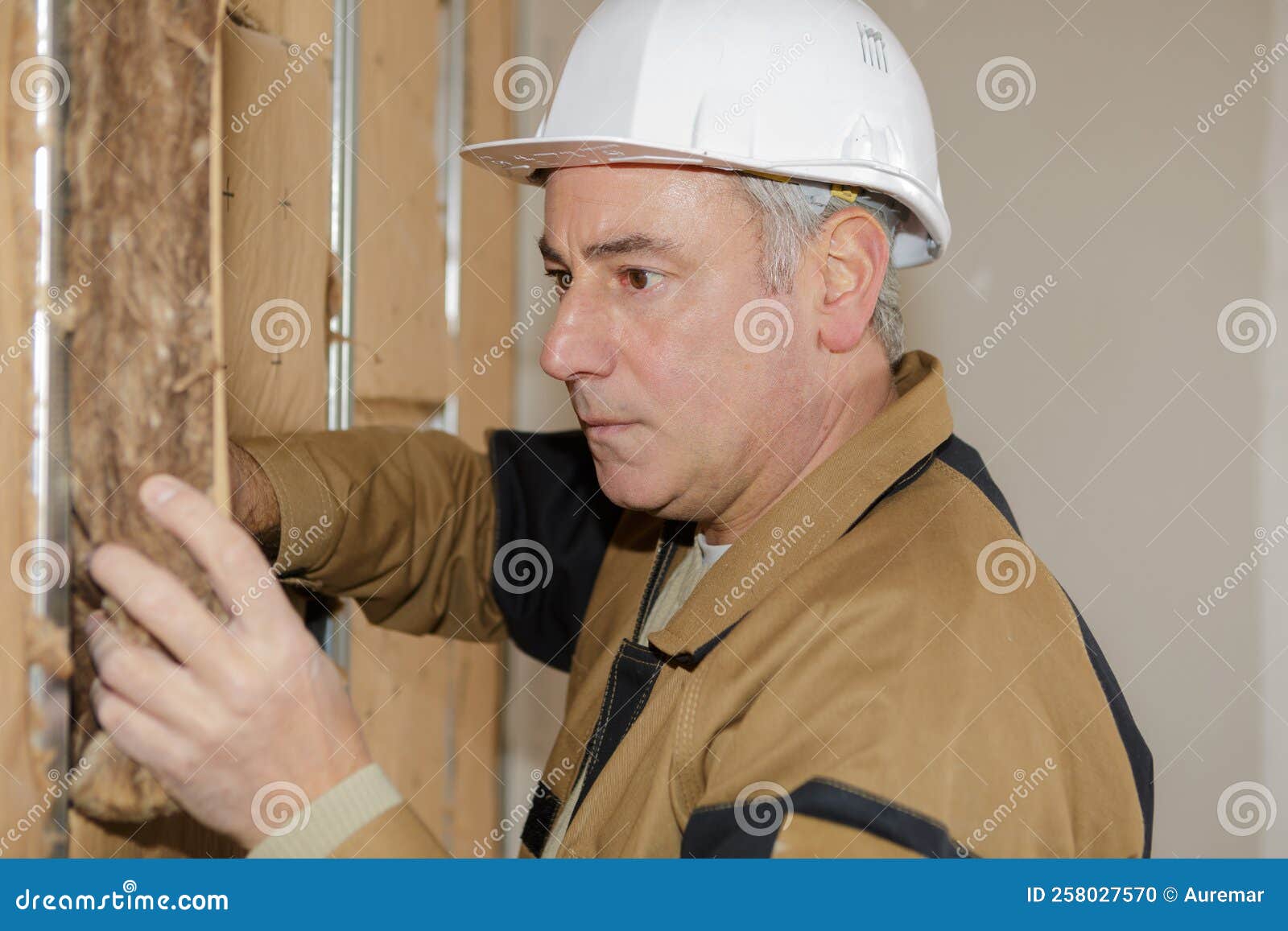 Mature Man Fitting Insulation into Walls Stock Photo - Image of person ...