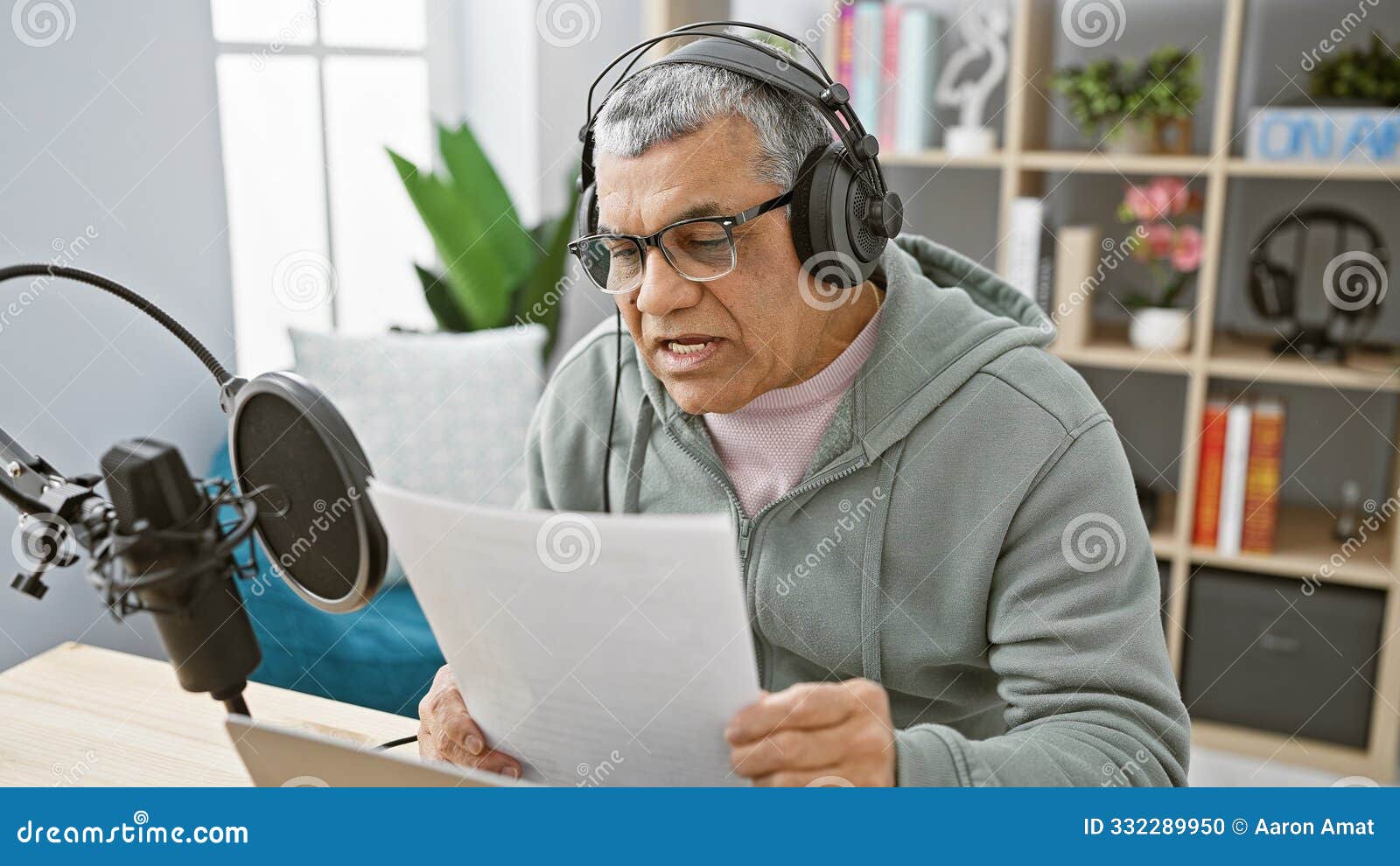 Mature Man with Headphones Reading Script in Radio Studio Interior ...