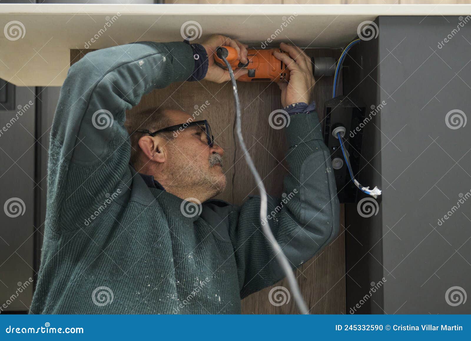 Mature Man Install Corner Socket with a Drill. Stock Photo - Image of ...