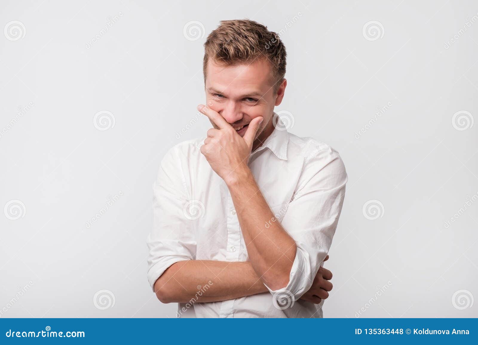 Mature Man Laughing And Covering His Mouth With Hand Over White