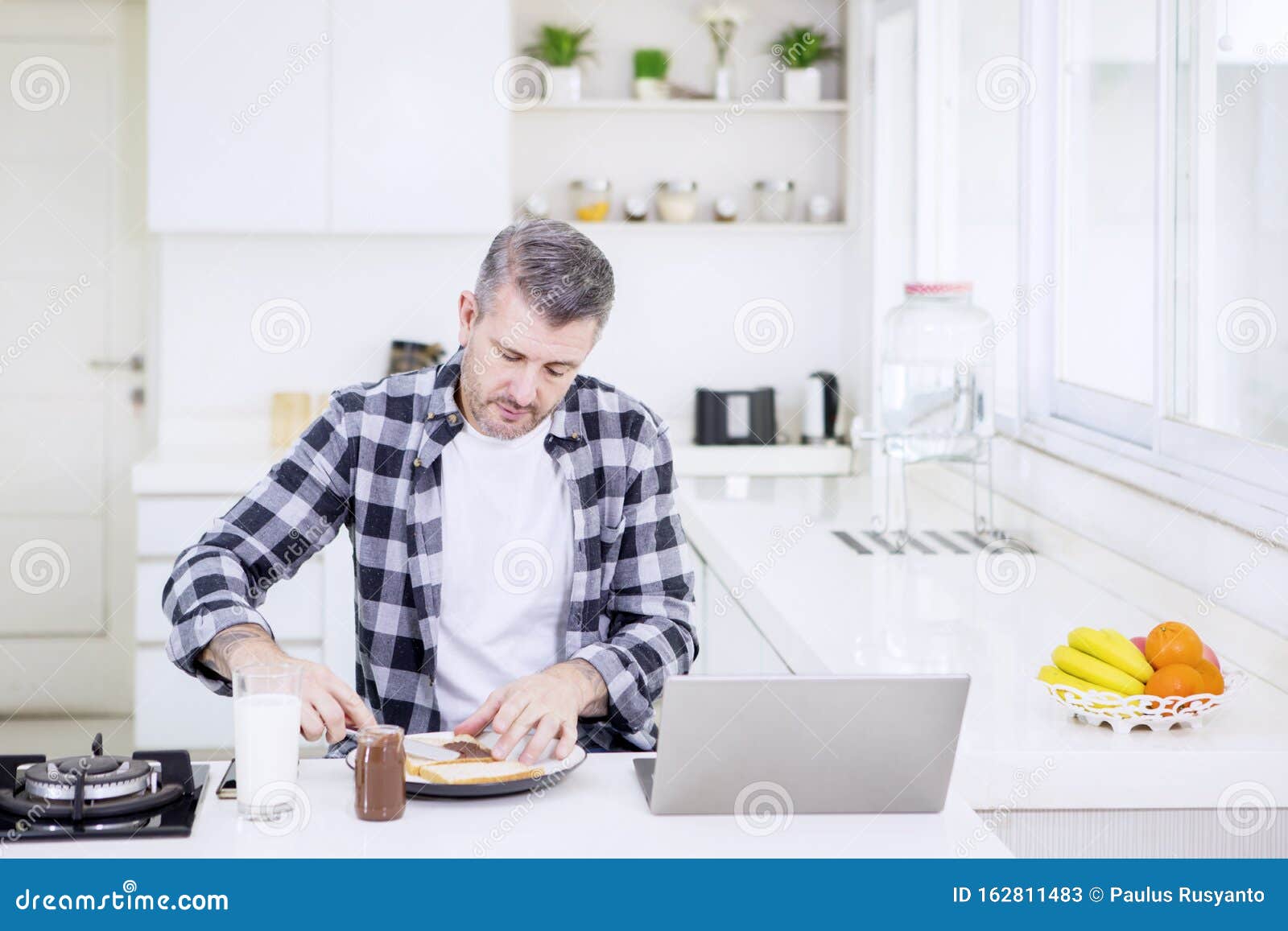 Mature Man Making Breakfast while Working Stock Image - Image of ...