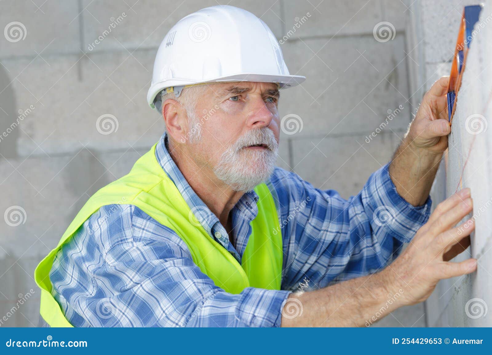 Mature man measuring wall stock image. Image of builder - 254429653