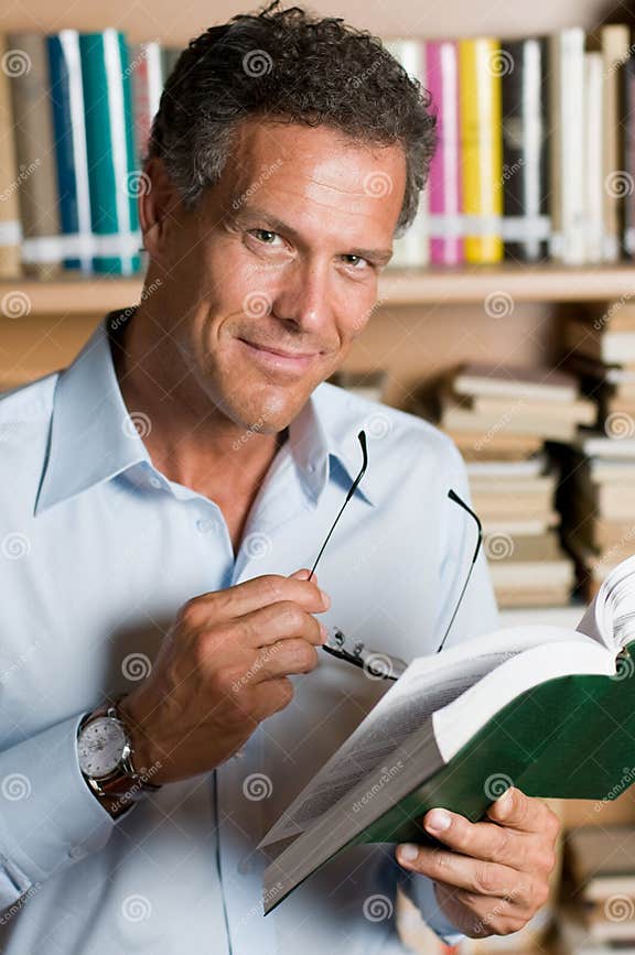 Mature man reading book stock photo. Image of librarian - 9915532