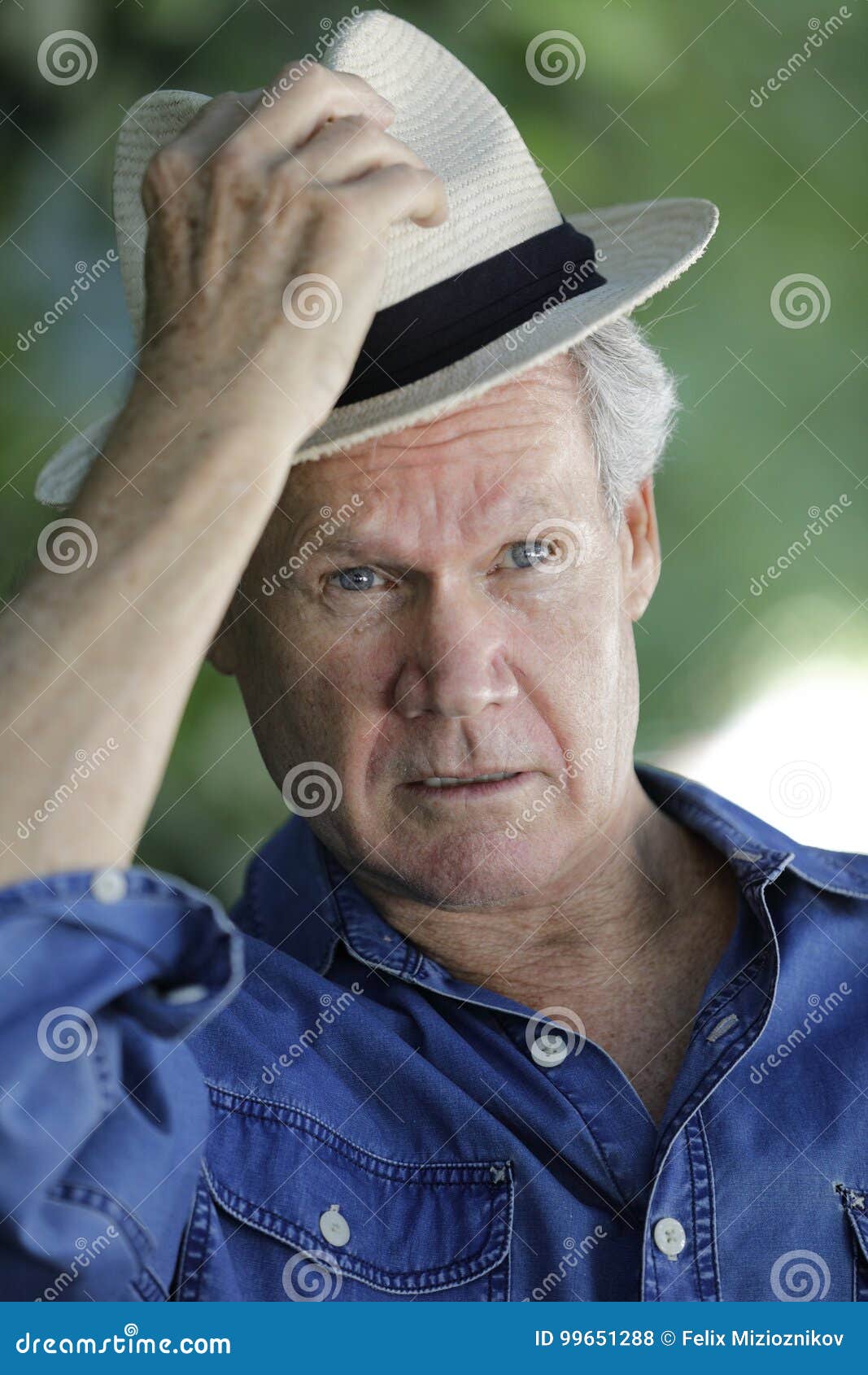 Mature Man Removing His Hat Stock Photo - Image of wellness, shot: 99651288