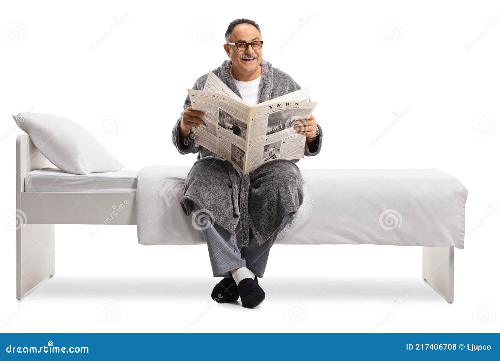 Mature Man in Robe Sitting on a Bed and Reading a Newspaper Stock Photo ...