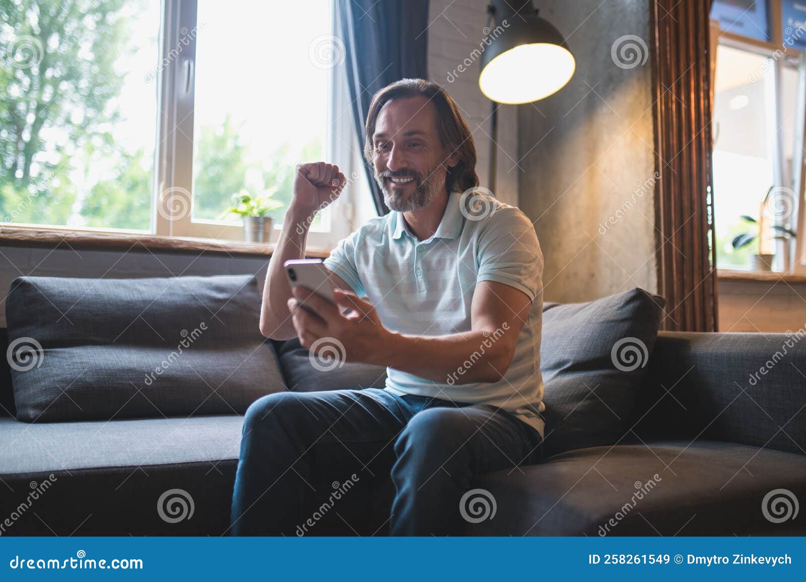 Mature Man Spending Time At Home And Watching Something On His