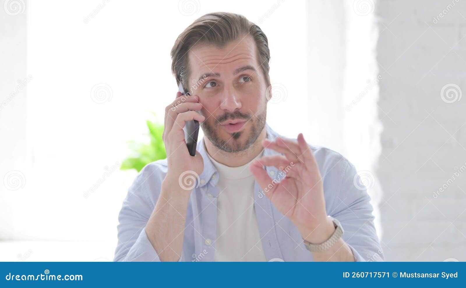 Young Man Talking on Phone, Discussing Work Stock Image - Image of ...