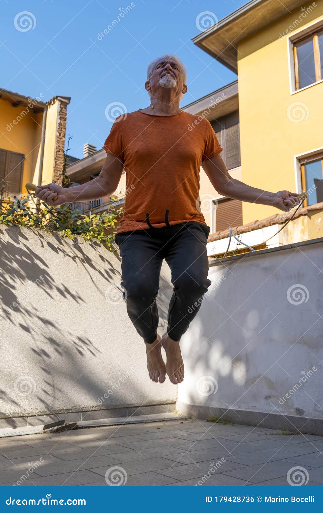 Mature Man is Training by Jumping Rope on the Terrace Stock Photo ...