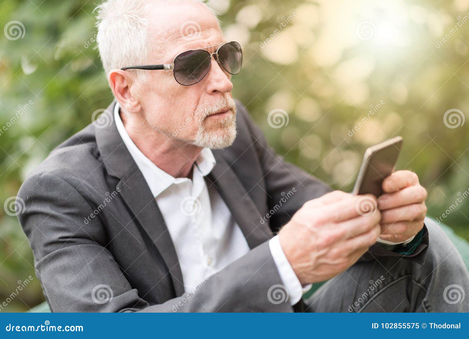 Mature Man Using His Mobile Phone, Light Effect Stock Image - Image of ...