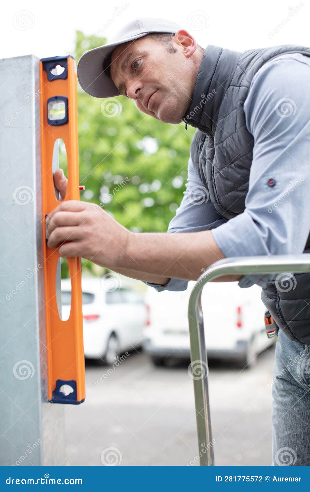 Mature Man Using Spirit Level in Car Park Stock Photo - Image of ...