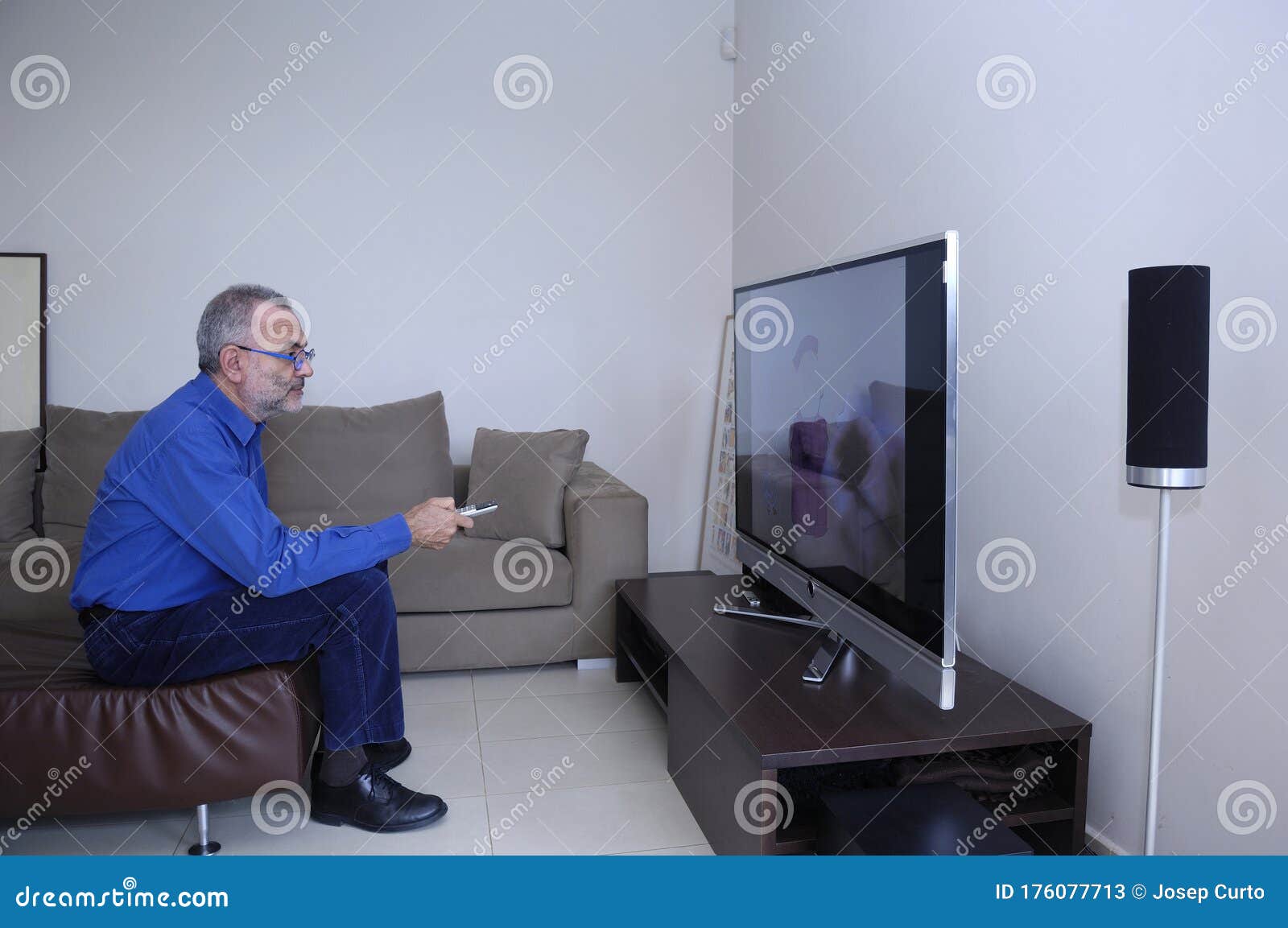 Mature Man Watching Television and Using Remote Control Stock Image ...