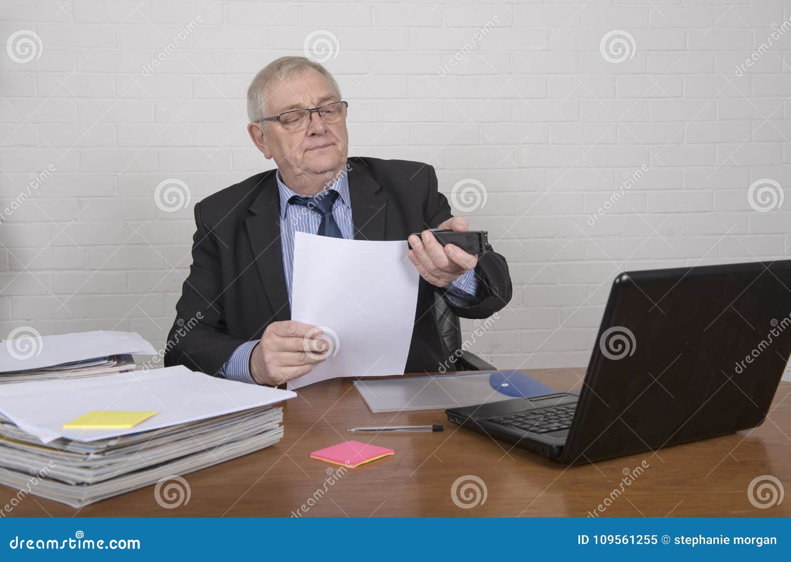 Mature Man at Work Looking at Paperwork Stock Image - Image of issues ...