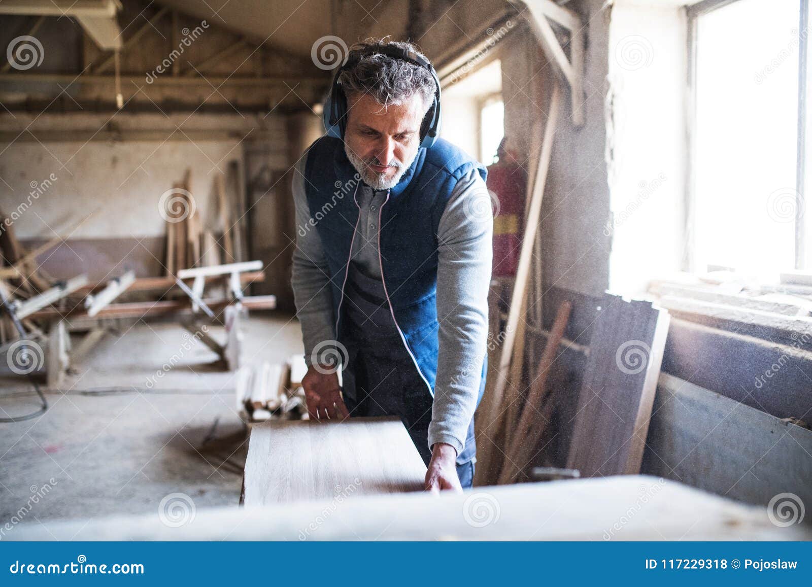 A Man Worker in the Carpentry Workshop, Working with Wood. Stock Photo ...