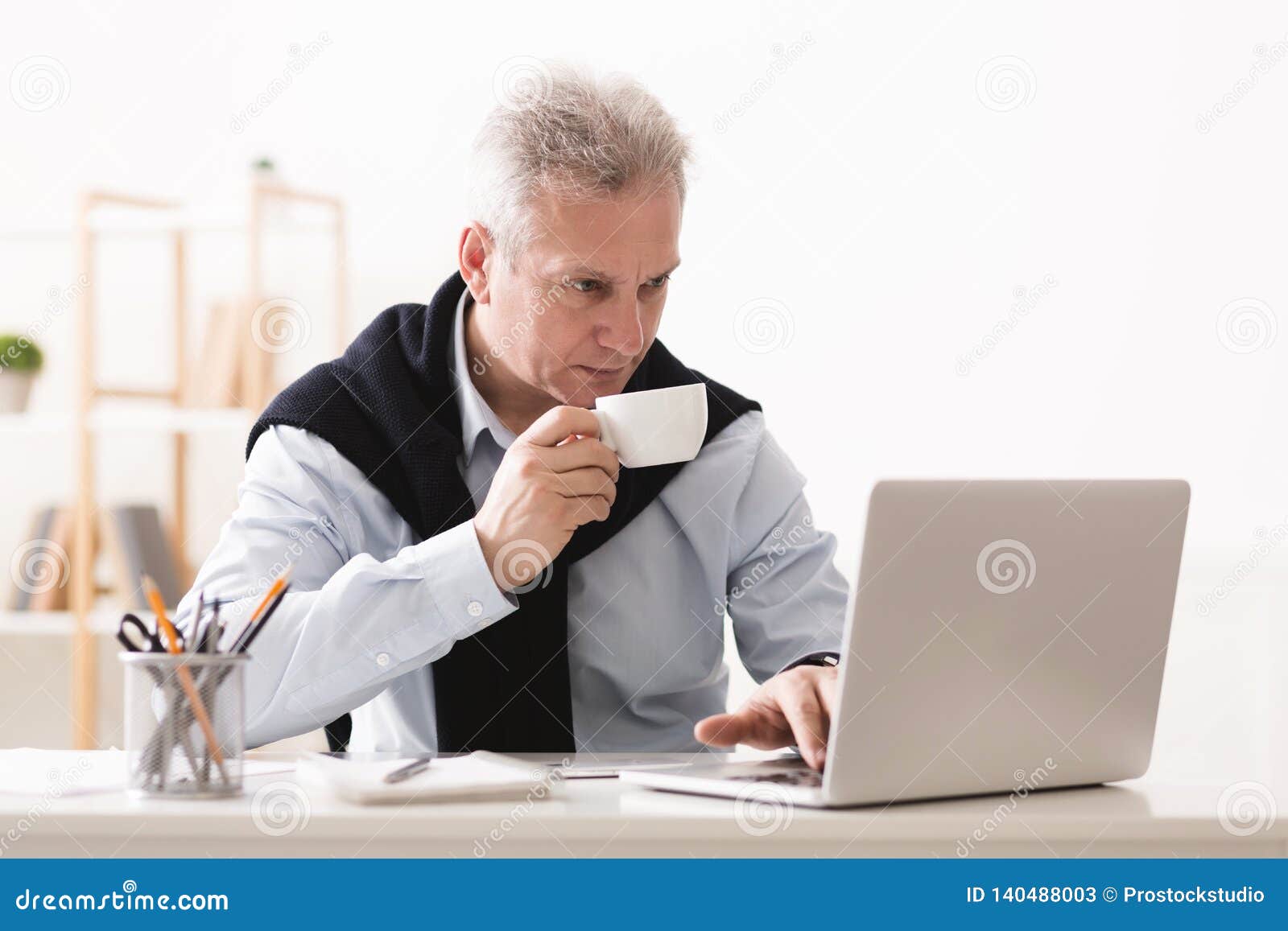 Mature Man Working on Laptop and Drinking Tea Stock Image - Image of ...