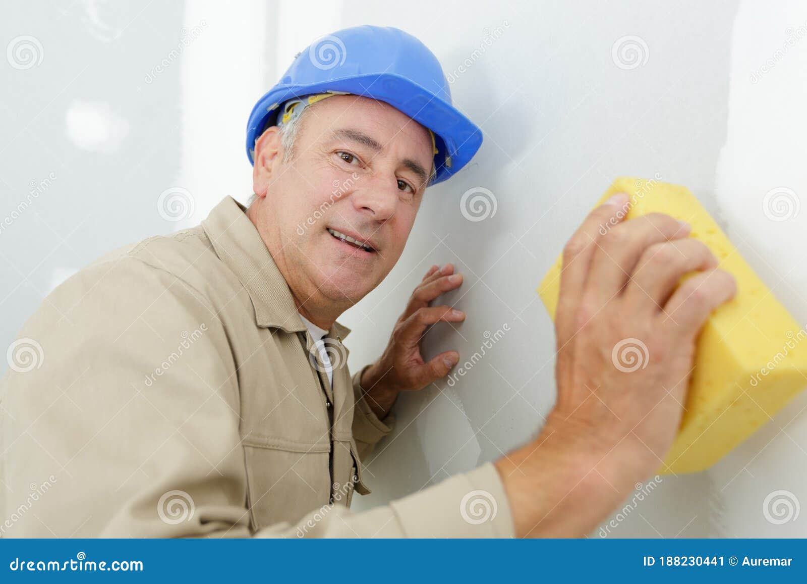 Mature Plasterer Finishing Wall with Sponge Float Stock Image - Image ...