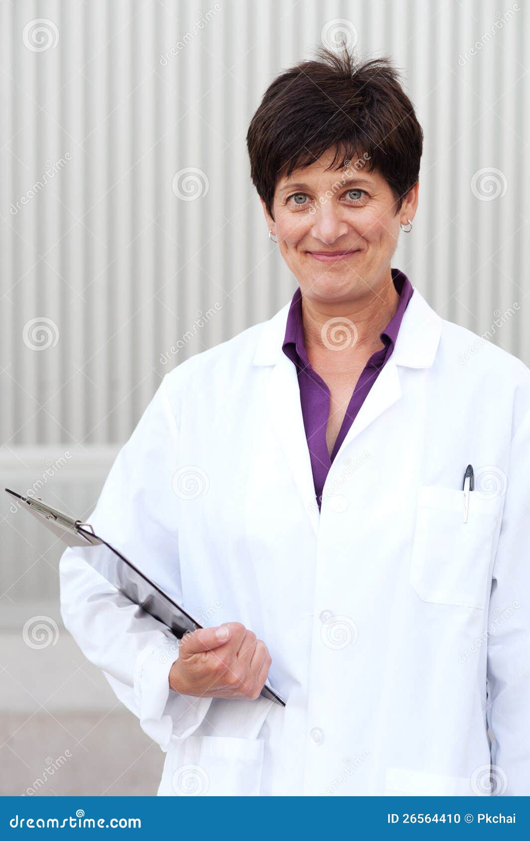 Mature Professional Woman Standing Confidently In Office With Arms ...