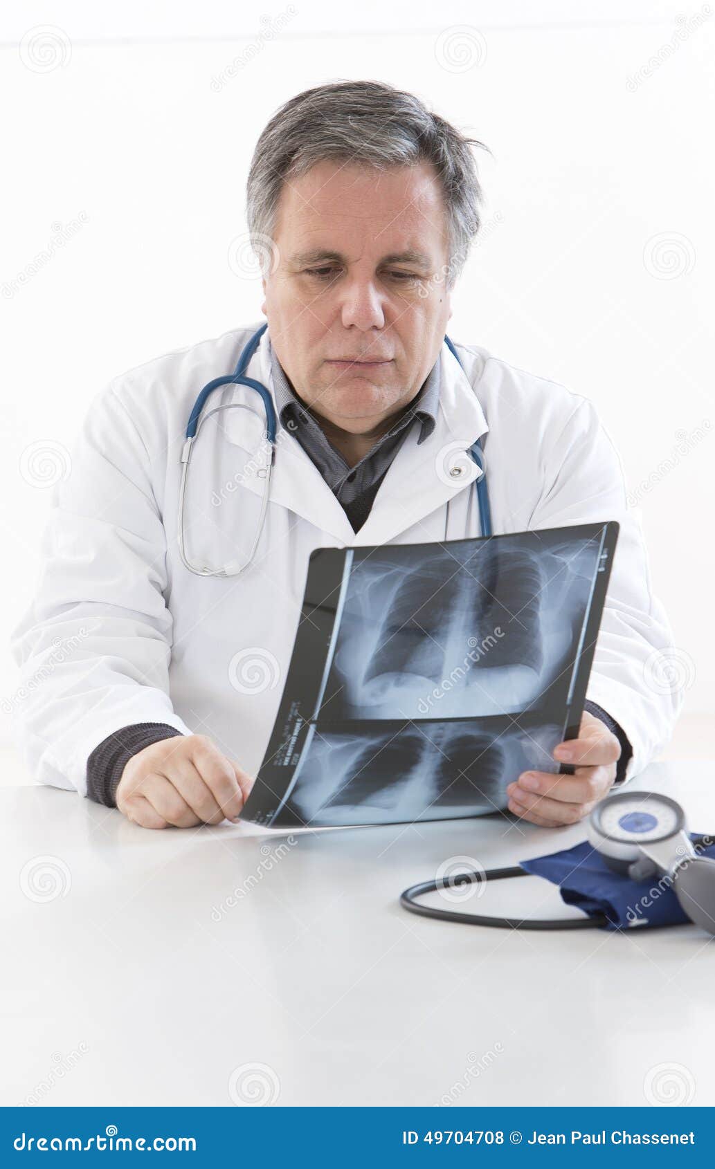 Mature Radiologist Examining an X-ray Stock Photo - Image of limbs ...