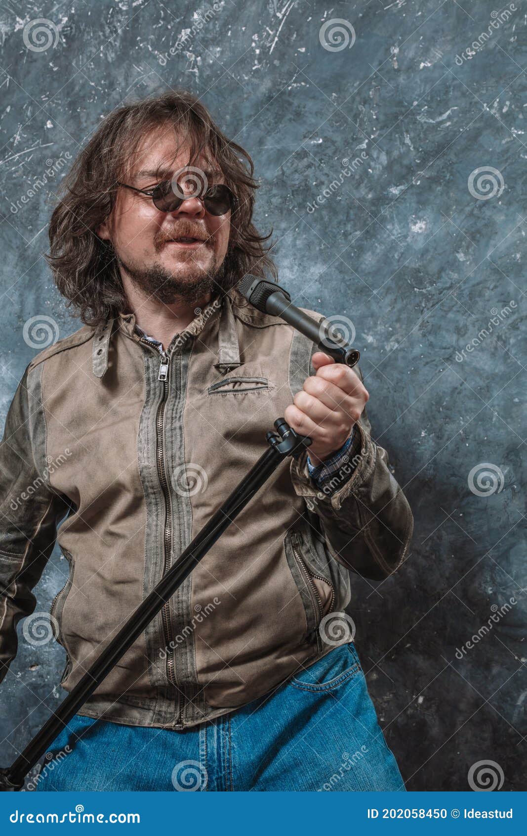 Mature Rocker with Microphone Emotional Studio Portrait. Stock Photo ...