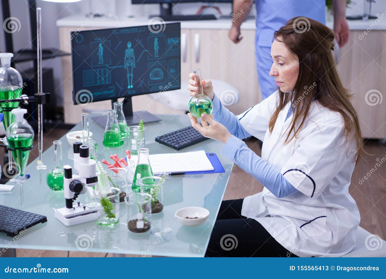 Mature Scientist Working with a Green Solution in a Research Lab Stock ...