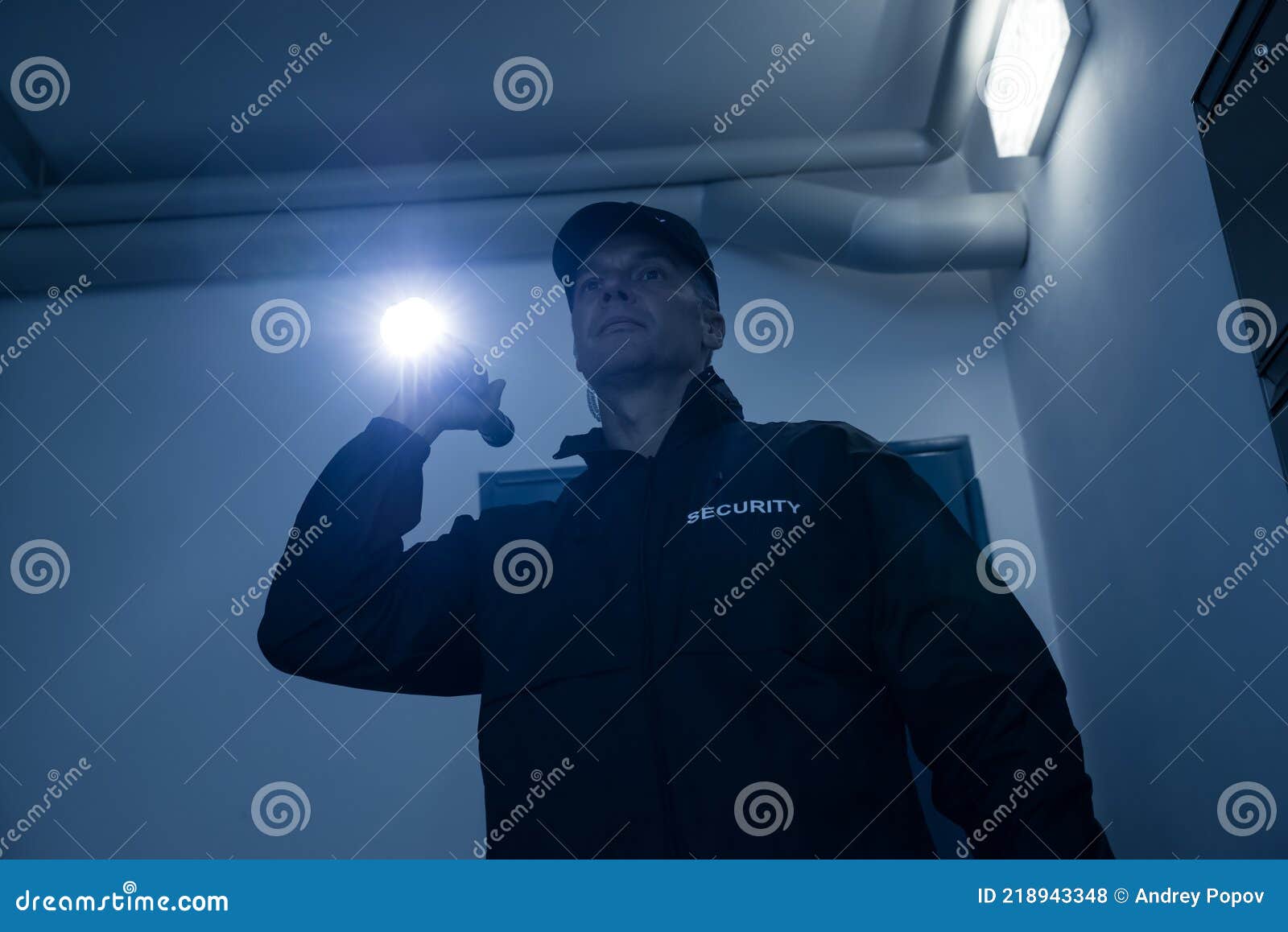 Security Guard Searching with Flashlight in Office Stock Photo - Image ...
