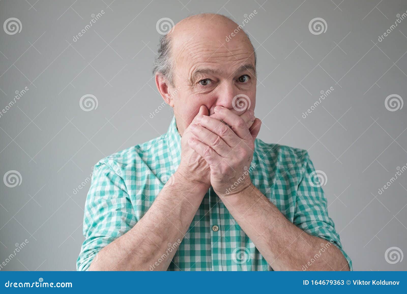 Mature Senior Hispanic Men Covering His Mouth By Hand Stock Image