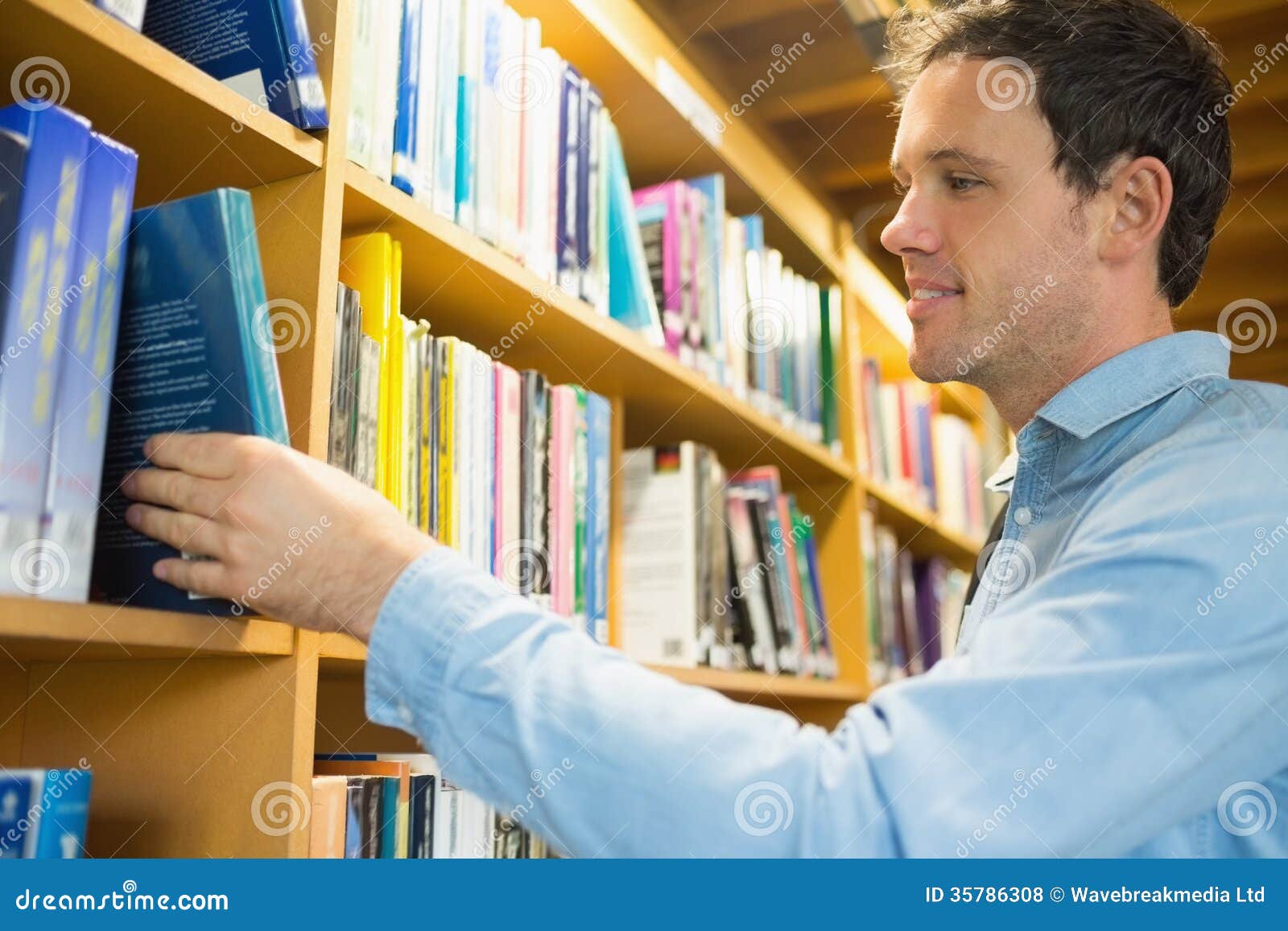 Mature Student Selecting Book from Shelf in Library Stock Photo - Image ...