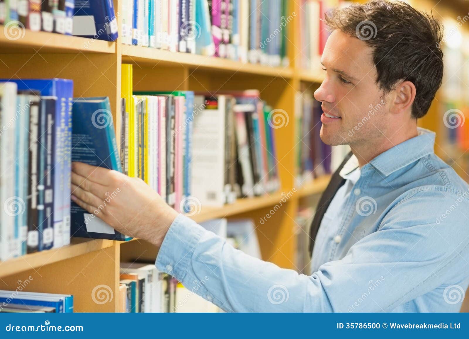 Mature Student Selecting Book from Shelf in Library Stock Photo - Image ...