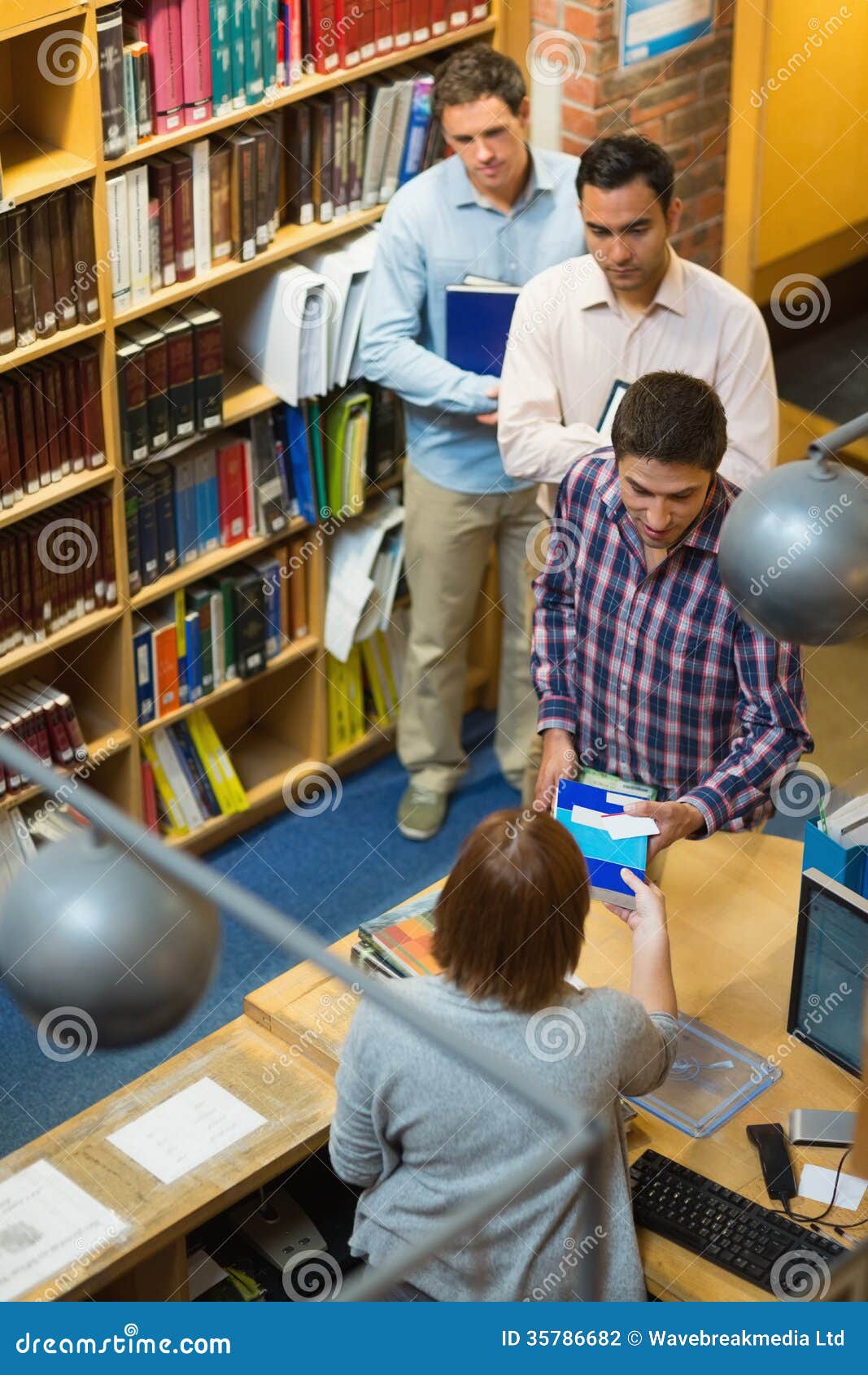 Mature Students at Counter in College Library Stock Photo - Image of ...