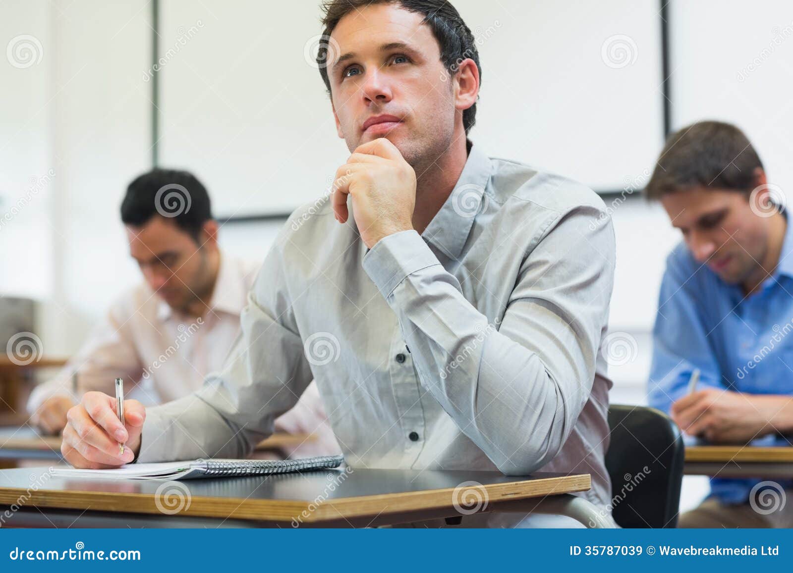 Mature Students Taking Notes in Classroom Stock Image - Image of ...