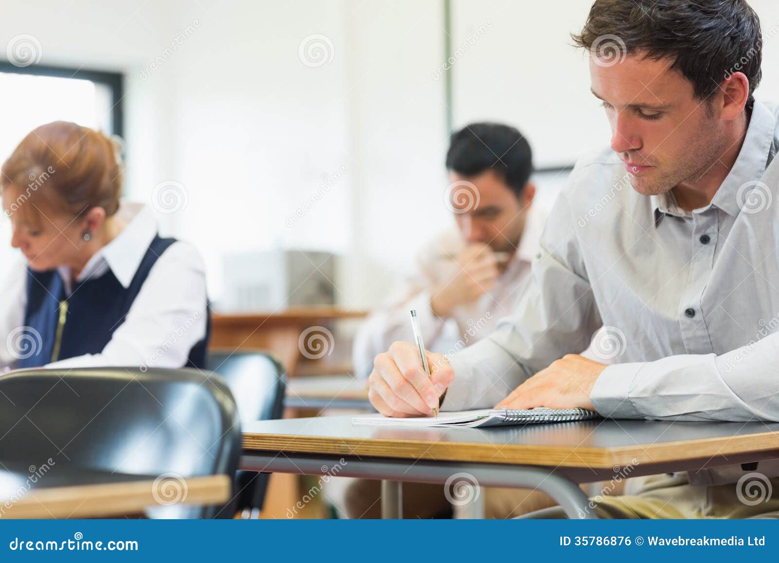 Mature Students Taking Notes in Classroom Stock Photo - Image of ...