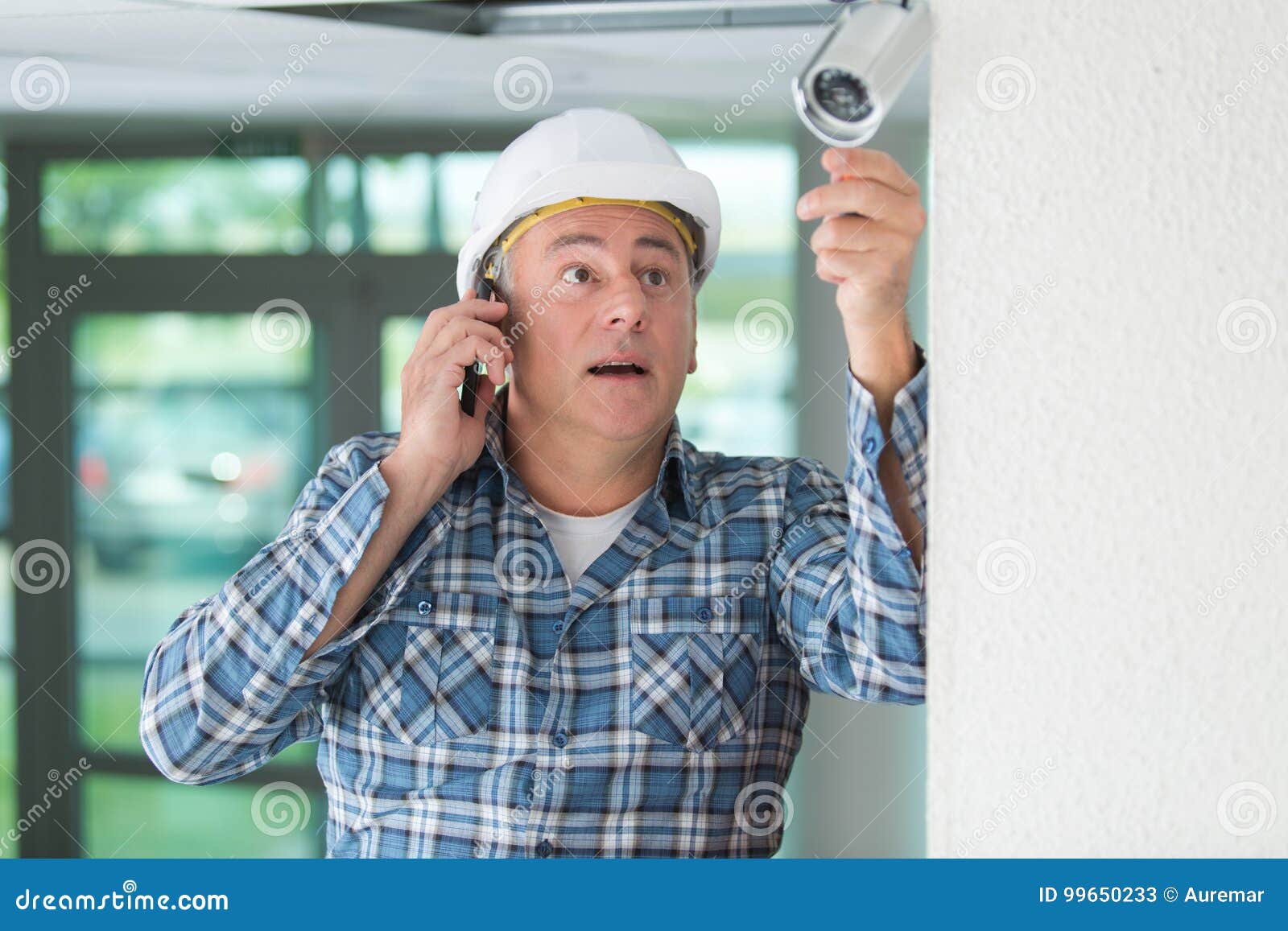 Mature Technician Installing Cctv and Talking on Phone Stock Image ...