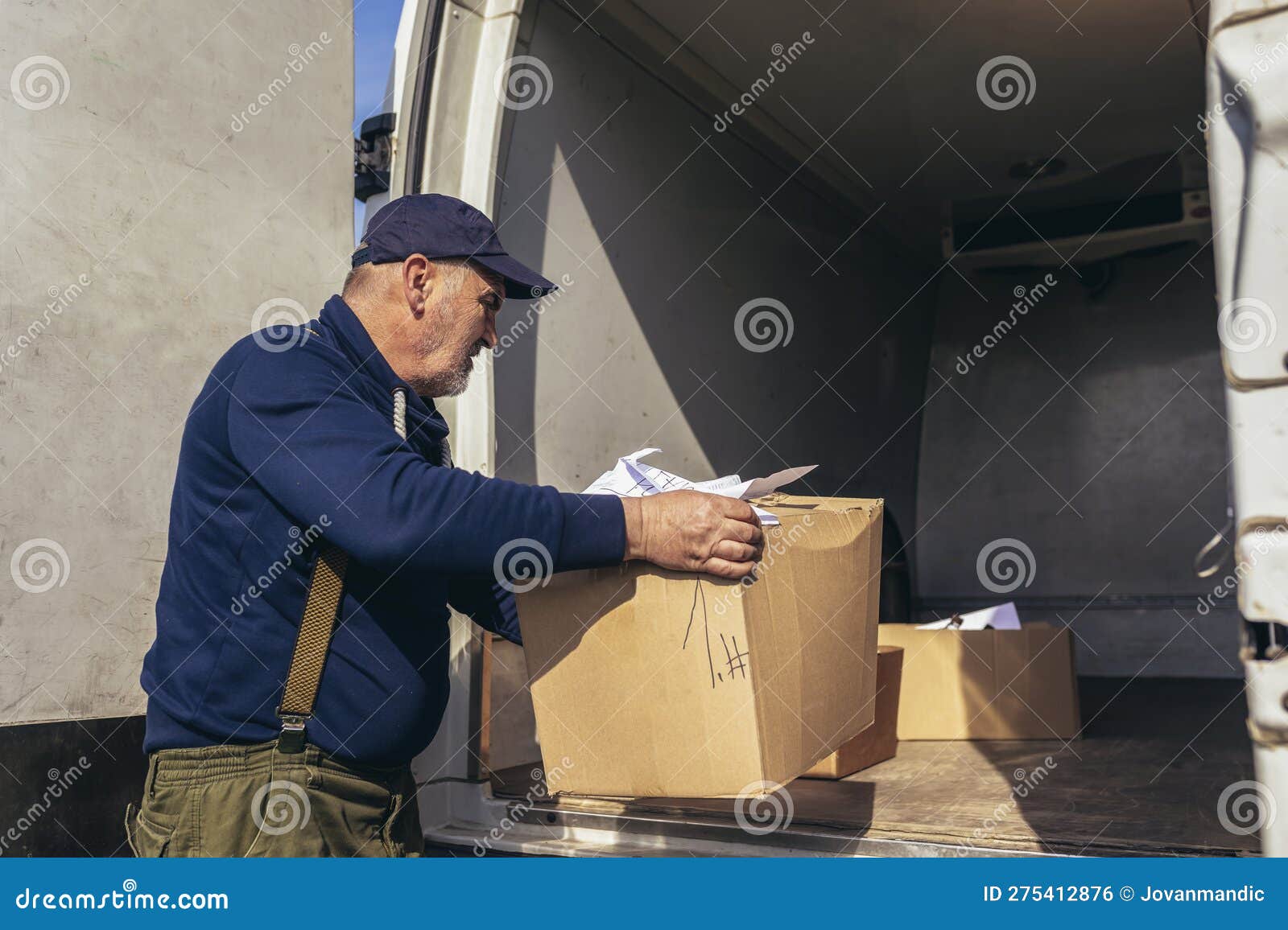 Van Driver Takes the Boxes Out of the Vehicle Stock Photo - Image of ...