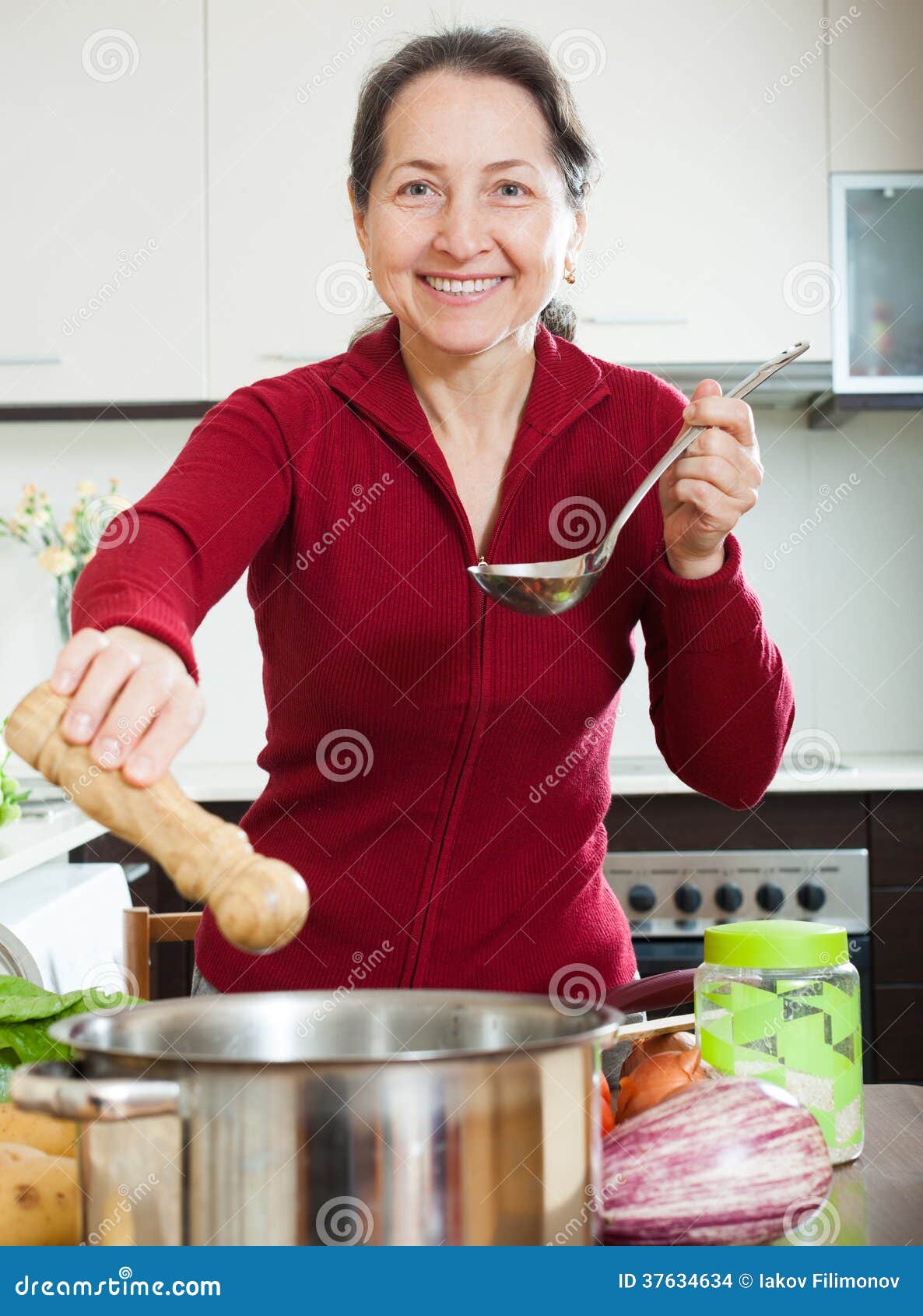Mature Woman Adding Seasoning into Pan Stock Photo - Image of interior ...
