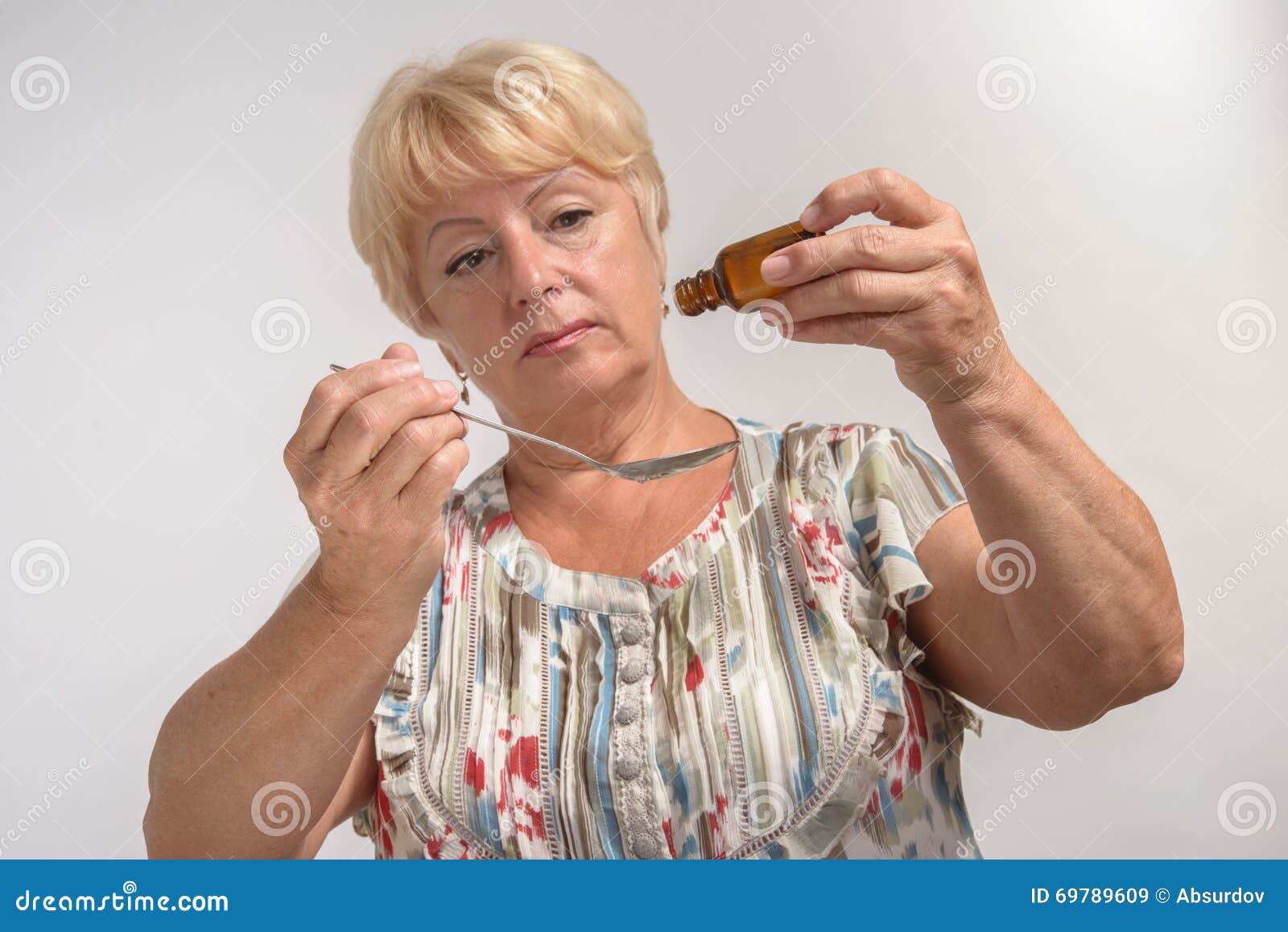 Mature Woman Dripping Medicine into a Spoon Stock Image - Image of cure ...