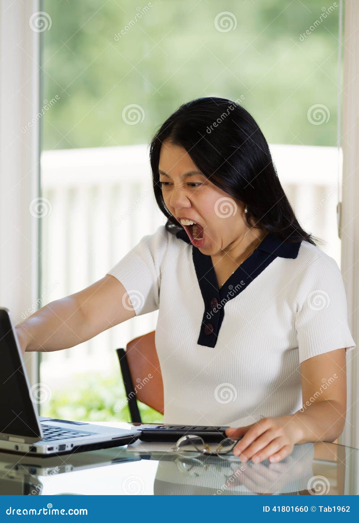 Mature Woman Expressing Extreme Anger while Looking at Her Computer ...