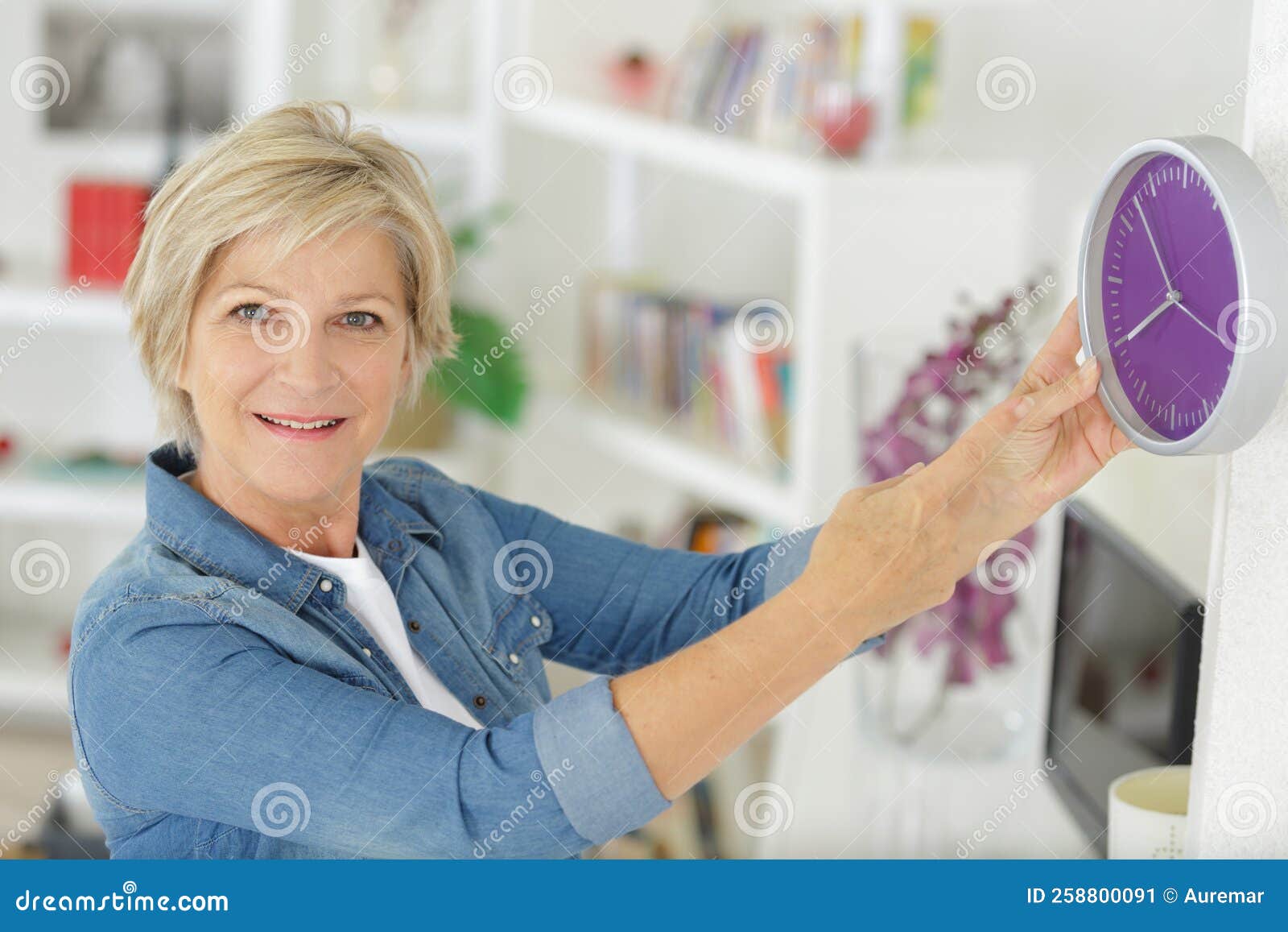Mature Woman Hanging Clock on Wall Stock Image - Image of smile, house ...