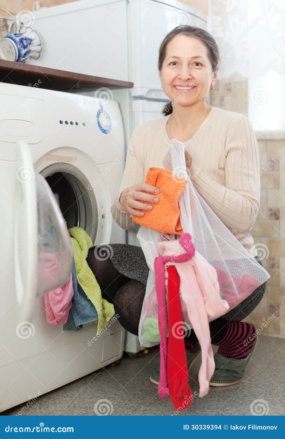 Mature Woman Loading the Washing Machine Stock Photo - Image of chores ...