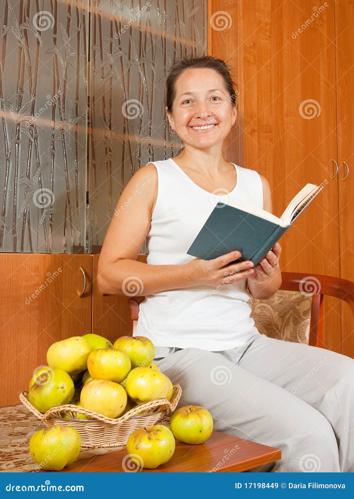Mature woman reading book stock image. Image of apples - 17198449