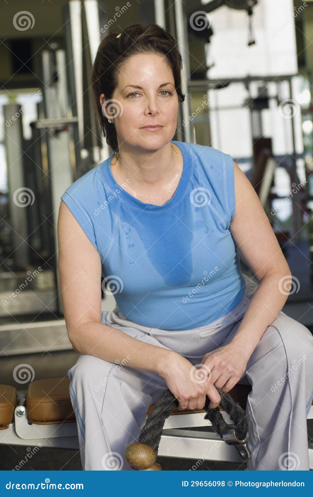 Mature Woman Sitting at Gym Stock Photo - Image of female, foreground ...