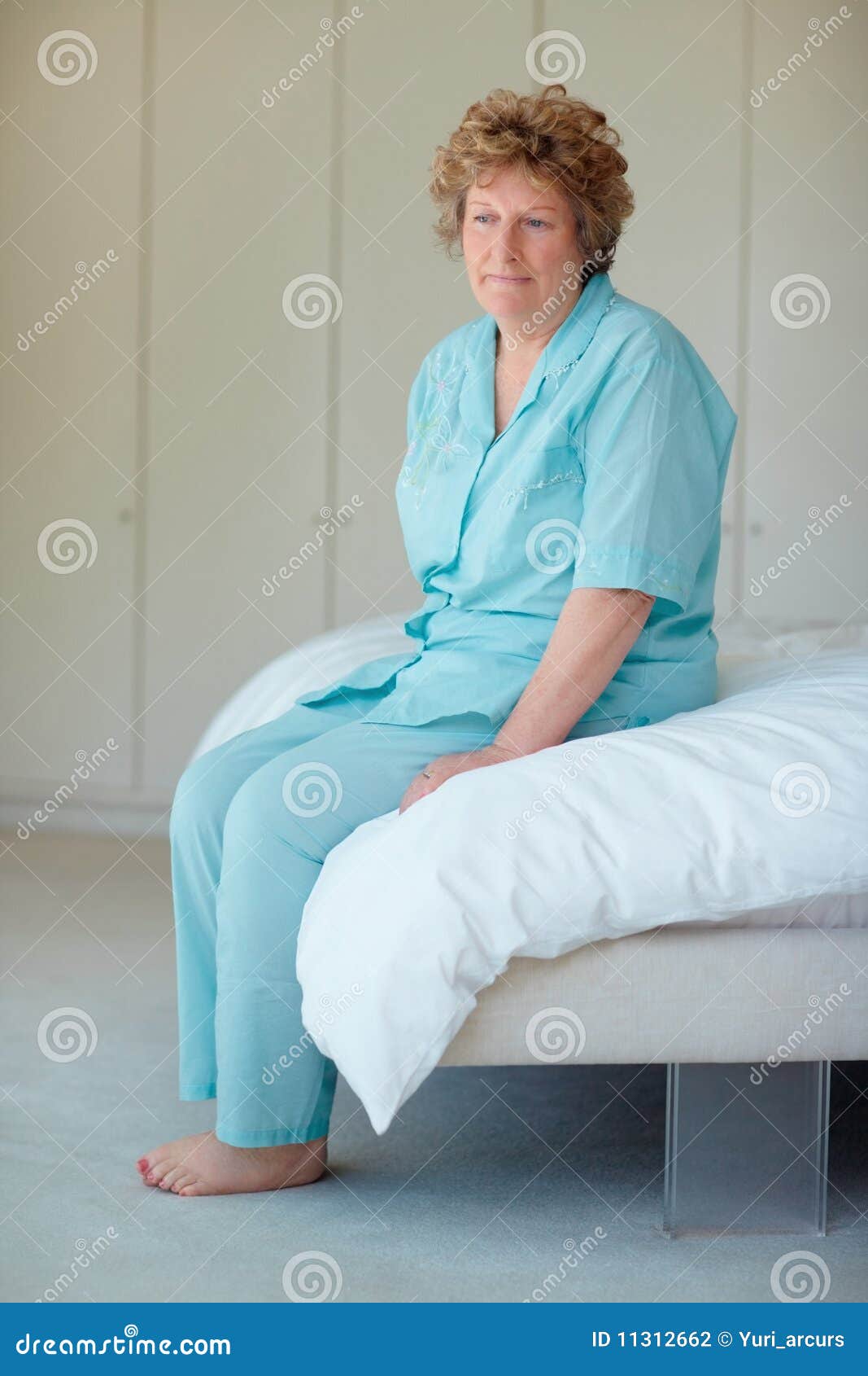 Mature Woman Sitting Isolated on a Bed Stock Photo - Image of citizen ...