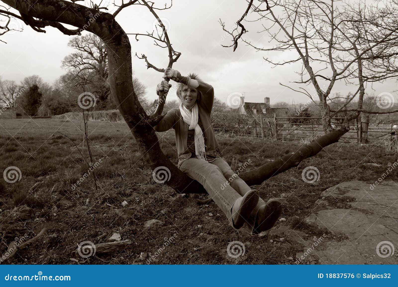 Mature Woman Sitting on a Tree Stock Photo - Image of outdoors, holding ...
