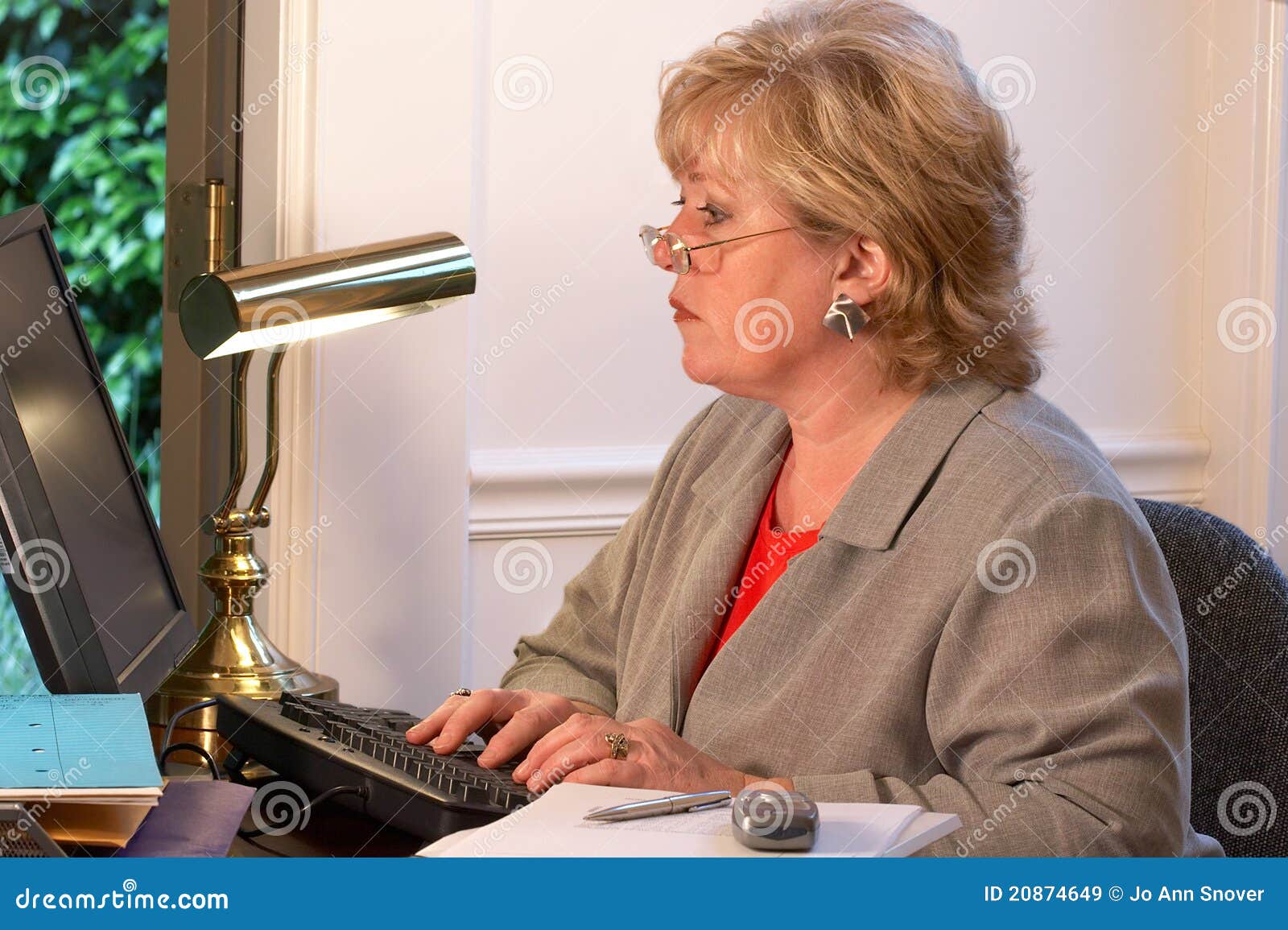 Mature woman typing stock image. Image of fifties, glasses - 20874649