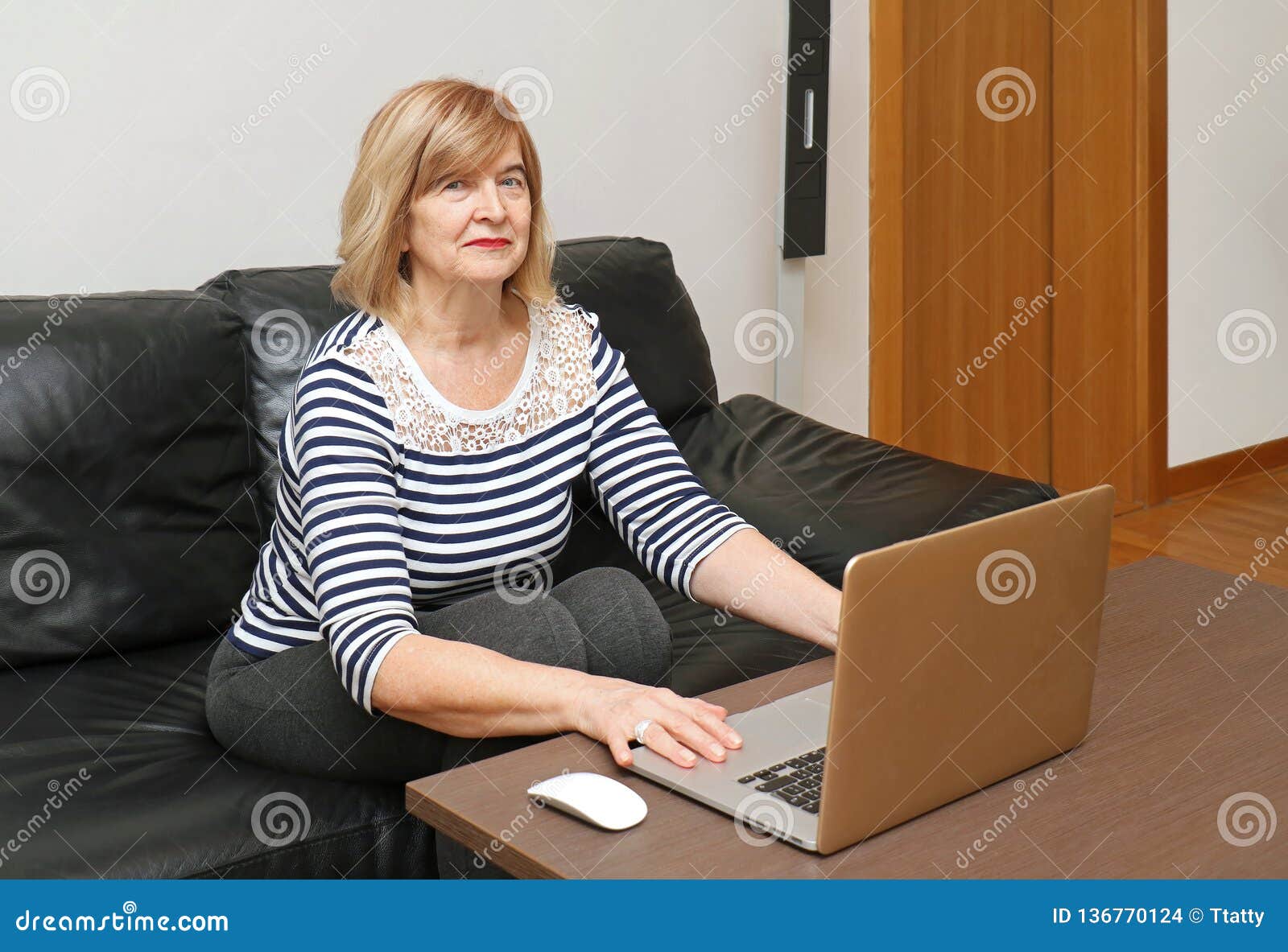 Mature woman using laptop stock photo. Image of middle - 136770124