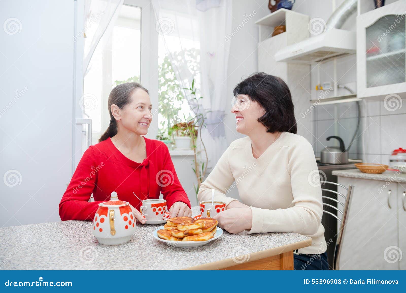 Mature Women Talking in Kitchen Stock Photo - Image of retired, home ...