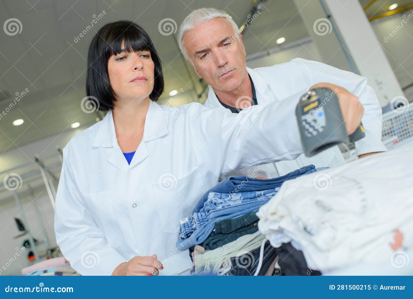 Mature Worker and Colleague Sorting Clothing Stock Image - Image of ...